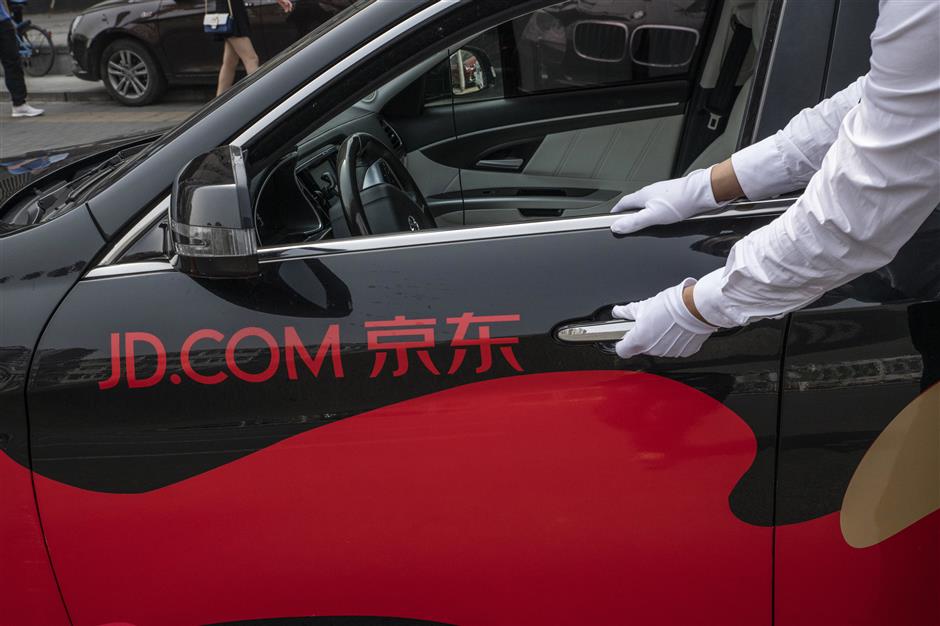 Online shopping in China goes luxury, with men in black delivering ...