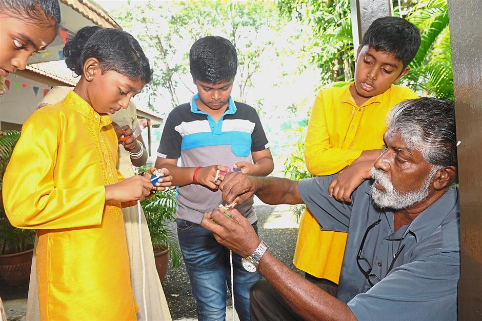Pupils and teachers enjoy playing and learning about Tamil traditional ...
