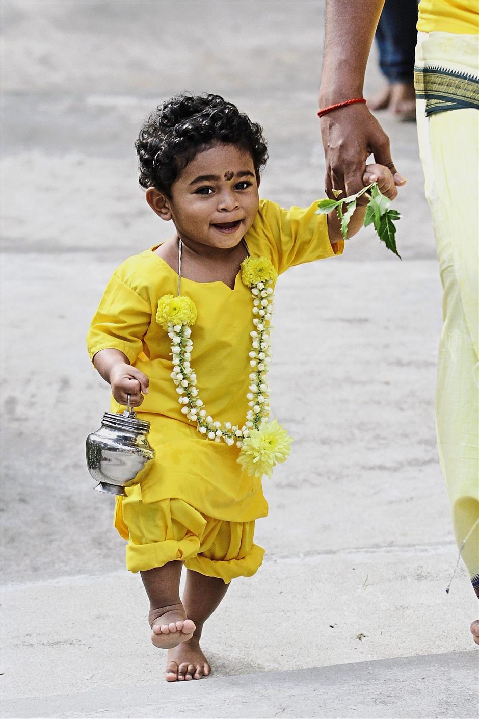 Couple with baby among temple devotees | The Star